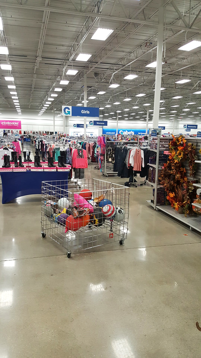 A shopper's paradise unfolds beneath industrial lighting, where department signs hang like retail constellations guiding you through this universe of markdowns.