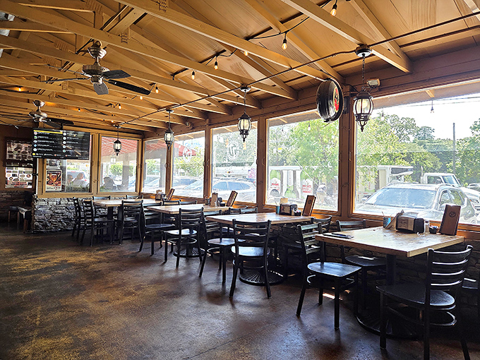 Sunlight streams through large windows, illuminating wooden ceiling beams and creating a rustic-modern vibe that says "stay awhile."