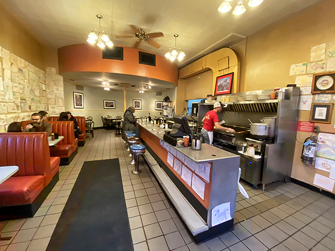 Classic diner perfection: red vinyl booths, swivel counter seats, and the symphony of spatulas conducting breakfast magic just feet from hungry patrons.