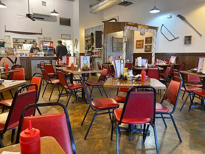 Red chairs await hungry patrons in a dining room where conversations flow as freely as the coffee. No designer needed&mdash;just honest comfort. 