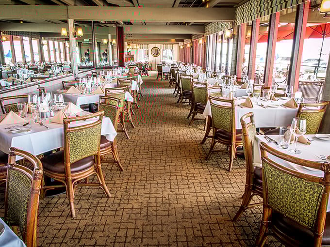 Floor-to-ceiling windows frame Newport Bay like nature's own dining room theater, where every table gets the premium view.