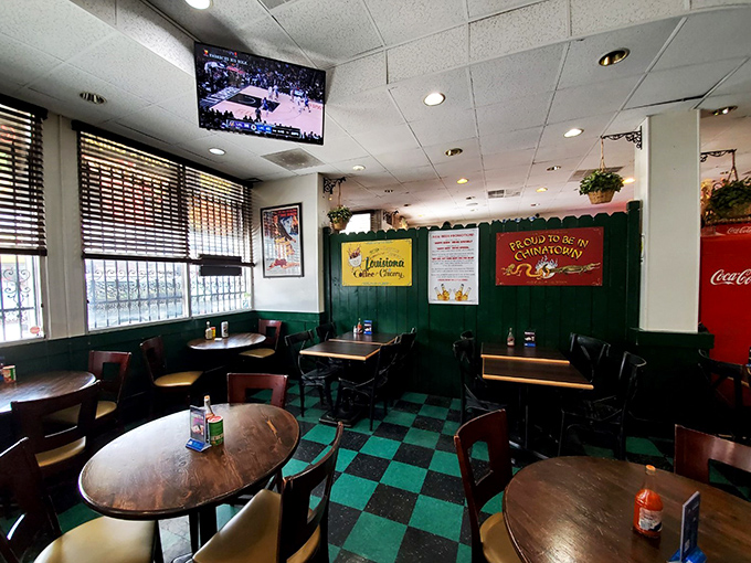 Inside, the classic green and black checkerboard floor sets the stage for culinary magic, while colorful Louisiana memorabilia transports you straight to the French Quarter.