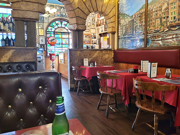 Step inside and you're transported to a bygone era where stained glass, wooden booths, and Italian murals create the perfect backdrop for carb-laden confessions.