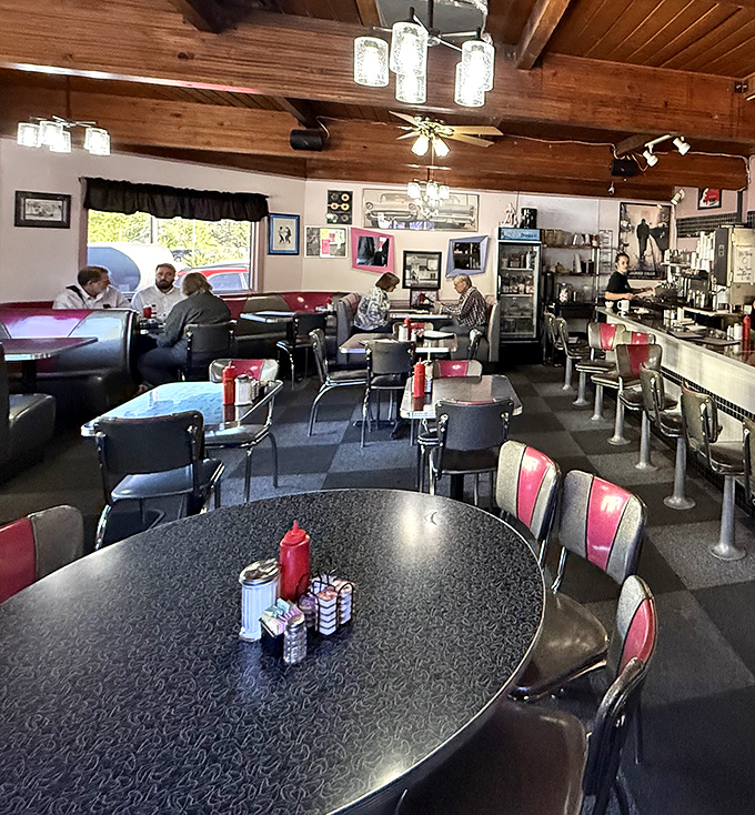 Classic diner magic happens under wooden beams, where chrome tables and pink-backed chairs have witnessed countless morning revelations.