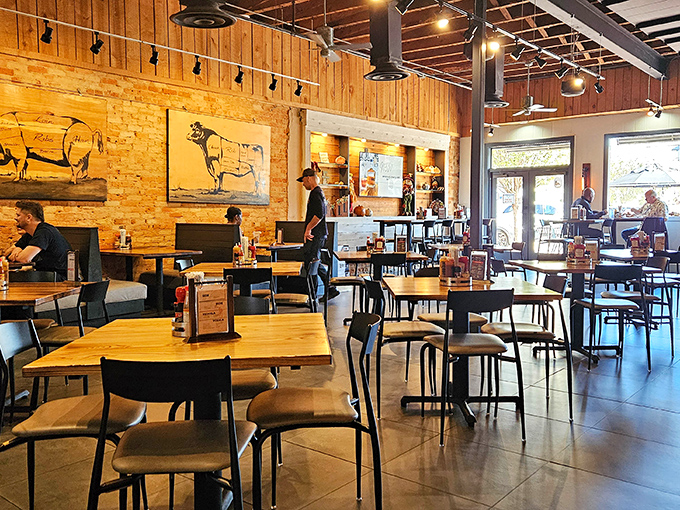 Rustic meets refined inside with exposed brick, wooden accents, and whimsical farm animal artwork that seems to say, "Yes, you're about to eat my relatives. They'd be honored."