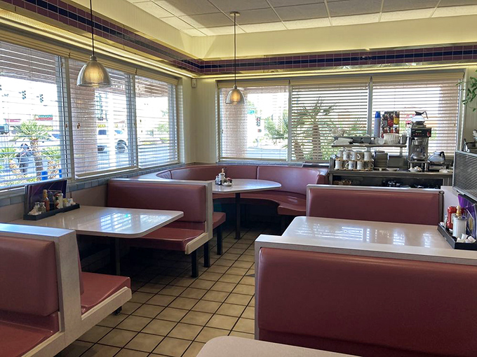 Classic burgundy booths and warm lighting create the perfect setting for contemplating life's big questions&mdash;like pancakes or waffles?