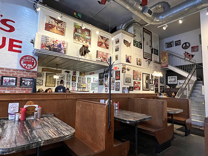 History hangs on every inch of wall space, creating a museum of barbecue memories where every booth feels like the best seat in the house.
