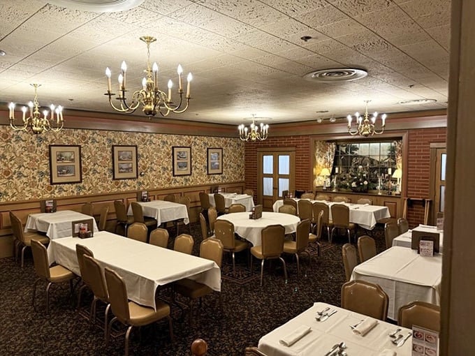 Elegant chandeliers cast a warm glow over crisp white tablecloths, creating an atmosphere where memories are made between bites.