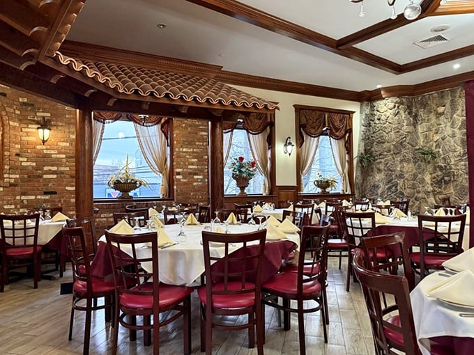 Dining room or time machine to Lisbon? Exposed brick, warm lighting, and burgundy chairs create the perfect backdrop for the meat parade that's about to commence.
