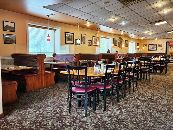 Classic diner geometry: wooden booths, patterned carpet, and just enough space between tables for privacy but not gossip immunity.
