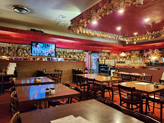 Chianti bottles with wax drippings hang like stalactites in this pizza cave of wonders. Each one represents a celebration that ended with "just one more slice."