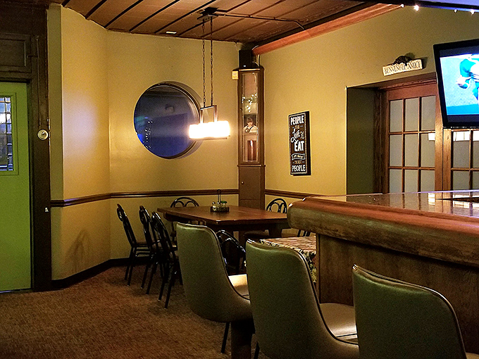 Those circular windows and warm yellow walls aren't trying to impress anyone, which is exactly why they do. Comfort begins before the food arrives.