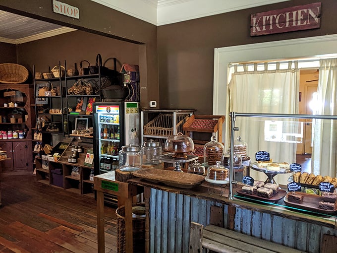 Behind this rustic counter lies a world of homemade delights, where glass domes protect treasures more valuable than gold &ndash; fresh-baked brownies.