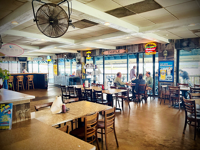 Inside, ceiling fans lazily spin above wooden tables where seafood dreams come true. The view's as much a part of the menu as the fish.