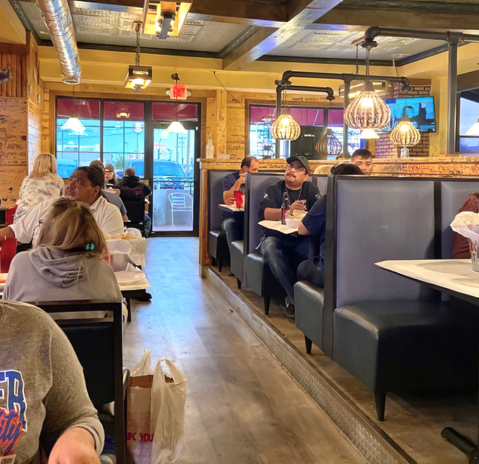 Industrial-chic meets seafood shack inside, where pendant lights cast a warm glow over diners preparing for delicious maritime adventures.