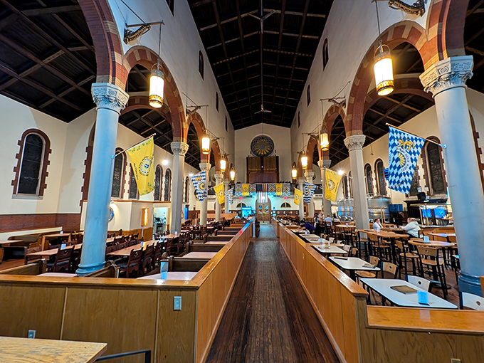 Where pews once held parishioners, tables now welcome diners beneath soaring arches and original stained glass windows.