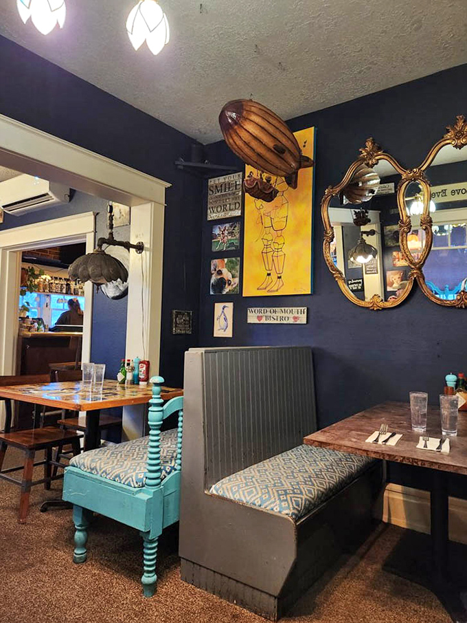 Navy blue walls adorned with eclectic art and vintage mirrors create the perfect backdrop for morning conversations and coffee revelations.