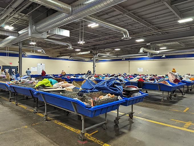 Blue bins stretch like an ocean of possibilities, each one a mystery box of forgotten dreams.