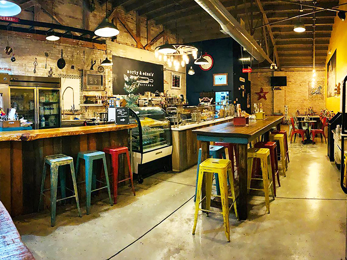 Industrial-chic meets small-town warmth in this interior, where colorful stools invite you to perch and watch culinary magic unfold at the counter.