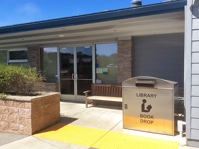 The local library stands ready with its welcoming bench, proving that even in paradise, sometimes you just need a good book.