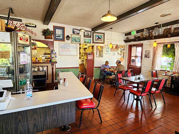 Inside, terra cotta tiles and red vinyl chairs create the perfect backdrop for morning conversations and coffee refills that never seem to end.