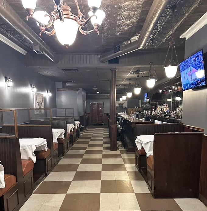 Step inside to discover a classic steakhouse ambiance where checkerboard floors lead to wooden booths and that magnificent tin ceiling tells stories of meals past.