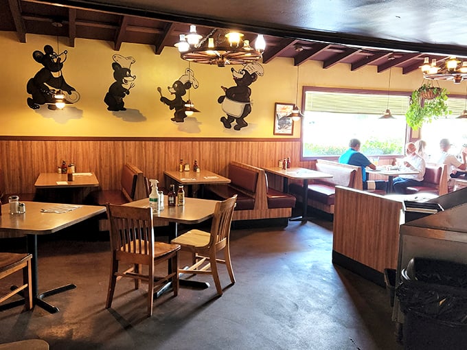Cartoon bears dance across wood-paneled walls while diners settle into comfortable booths. Nostalgia served alongside every plate.