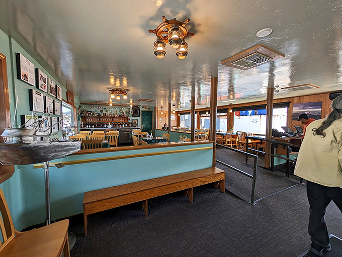 Nautical charm meets comfort inside, where ship lanterns cast a warm glow and every table feels like you've scored the captain's private dining room.