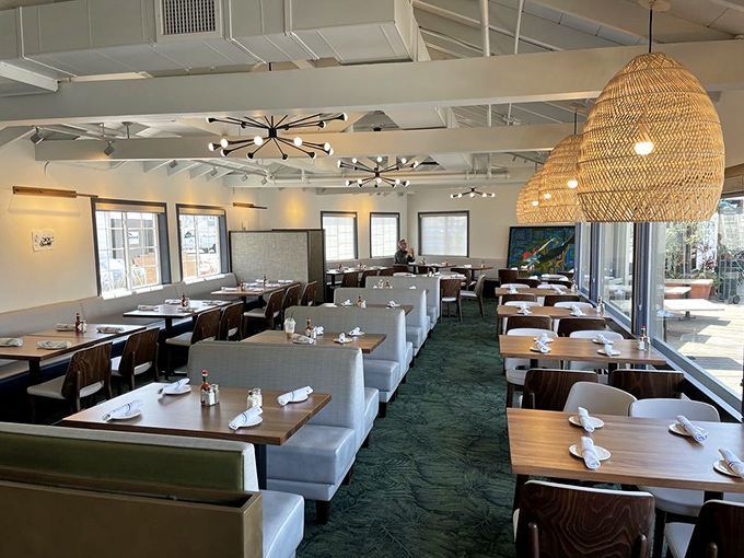 Bright, airy interiors with woven pendant lights create a sophisticated yet relaxed vibe. Those seafoam carpets cleverly echo the ocean just beyond the windows.