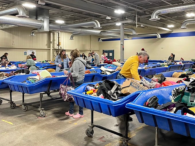 Treasure hunters in their natural habitat, methodically combing through blue bins like archaeologists at the world's most eclectic dig site.