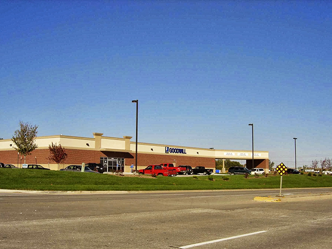Under clear blue Iowa skies, this Goodwill location stands ready for exploration. The thrill of the hunt begins where that red pickup truck is parked.