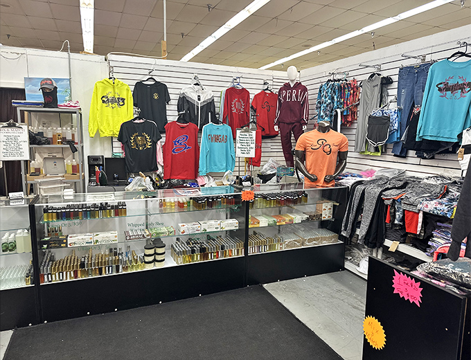 Fashion meets function at this colorful vendor stall, where graphic tees and accessories await their forever homes like eager puppies at a shelter.