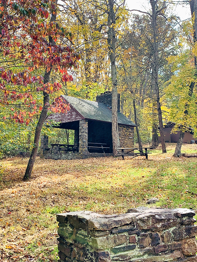 This rustic stone pavilion, framed by autumn's fiery palette, offers respite to weary hikers. Pennsylvania's version of a five-star lunch spot.