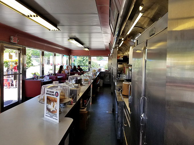 Classic diner geometry at its finest&mdash;a narrow galley kitchen where culinary magic happens just inches from your counter seat, close enough to witness breakfast alchemy.