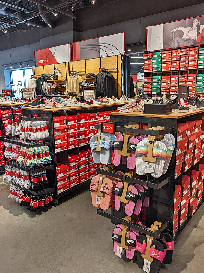 Rows of colorful Puma slides and sneakers stacked like a rainbow promise comfort without the usual wallet pain.