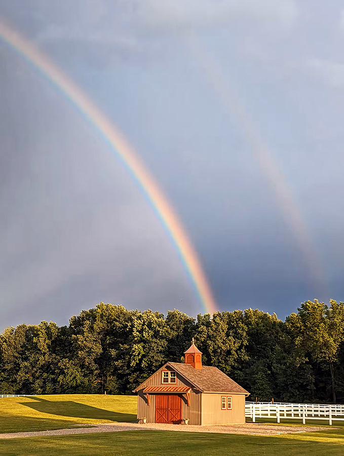 Nature's own light show! A perfect double rainbow arches over the barn, as if the universe itself is giving Erinwood Farms its seal of approval.