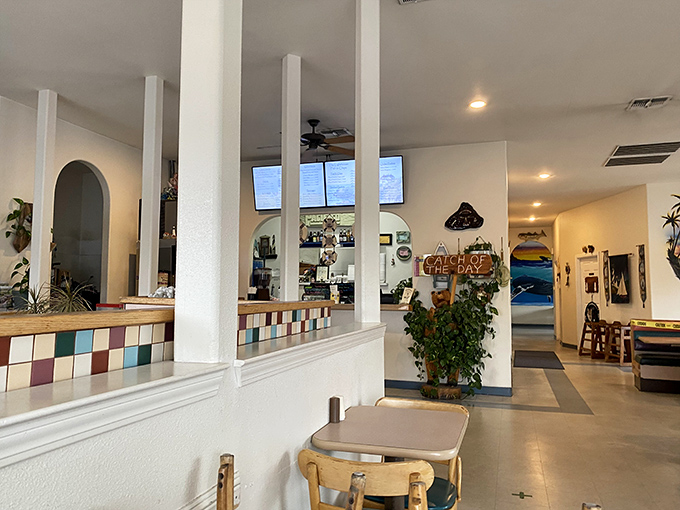 Clean white columns and colorful tiled accents create a cheerful coastal vibe. The nautical theme whispers rather than shouts&mdash;exactly as it should.