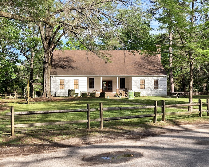 This charming white cabin isn't just photogenic—it's a time machine to simpler days when porches were for sitting and stories were for sharing.