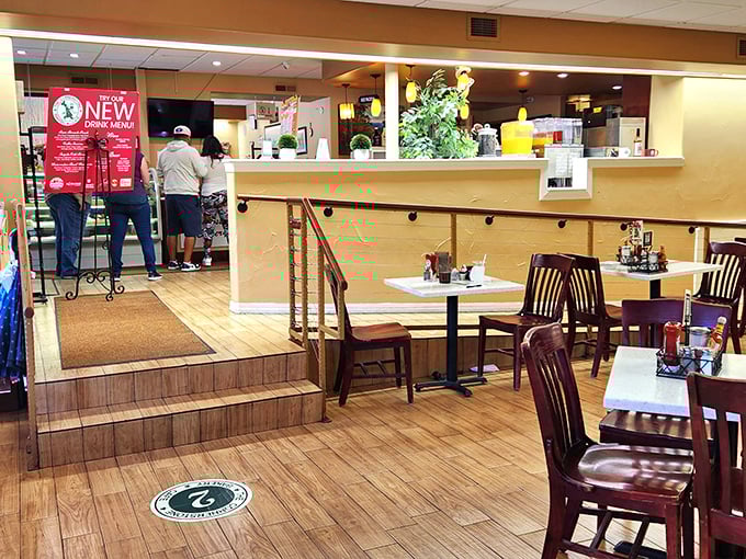 Multi-level dining creates intimate spaces within the warm interior. Like a well-crafted breakfast, this layout has layers that just work.