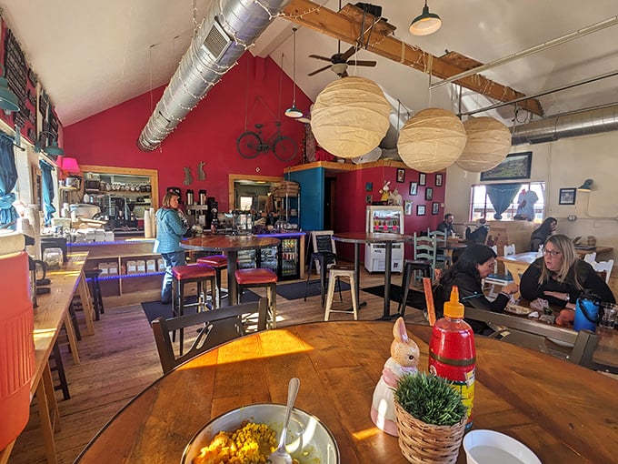 Vibrant red walls, paper lanterns, and that bicycle mounted like modern art—this isn't your grandmother's café, unless your grandmother was impossibly cool.