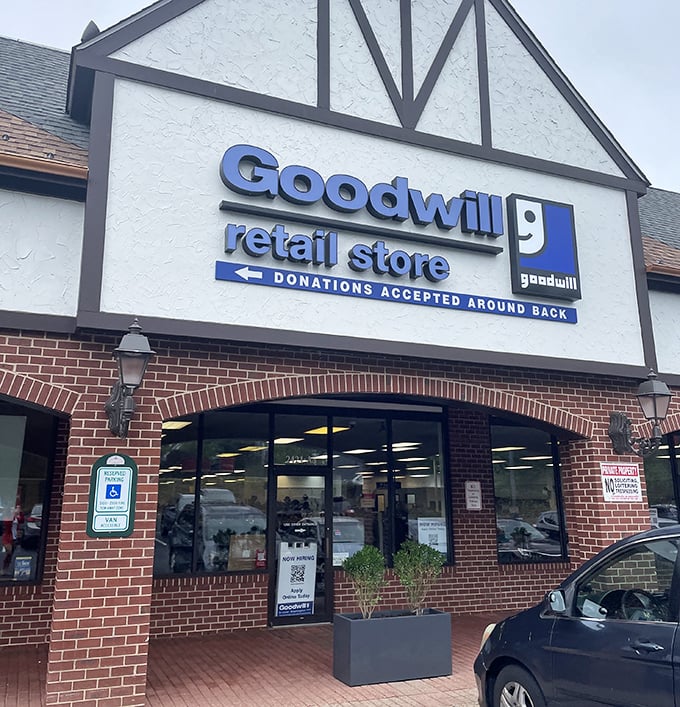 Blue signage beckons thrift enthusiasts like a lighthouse for bargain hunters. "Donations accepted around back" might as well say "Dreams delivered inside."