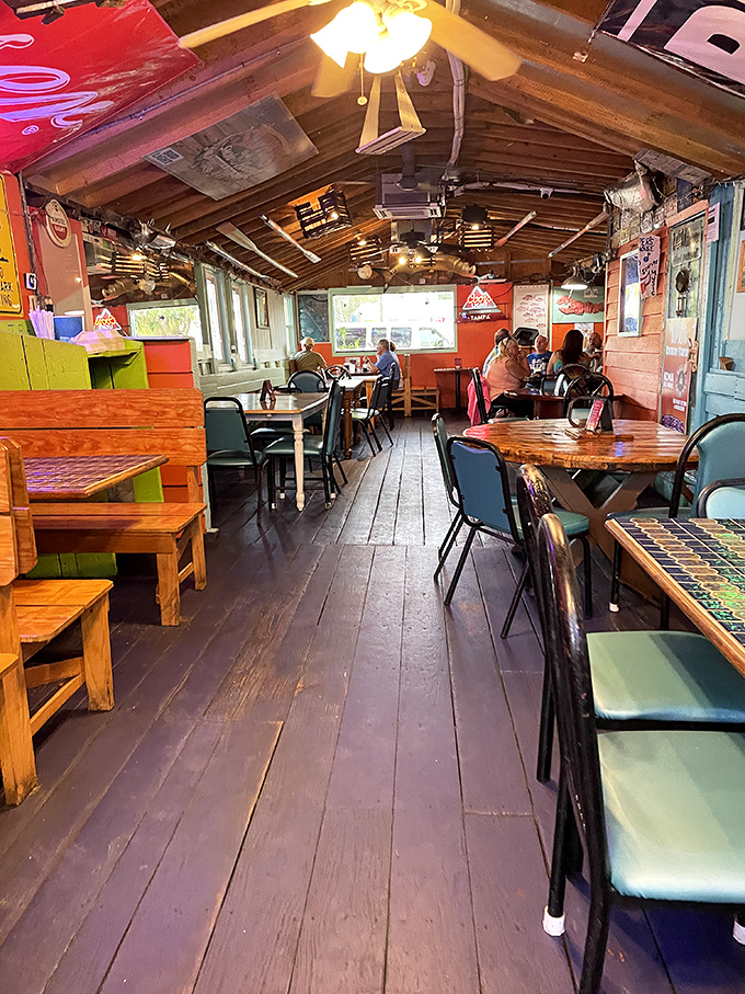 The rustic interior feels like dining in a friend's screened-in Florida porch that gradually expanded over decades, complete with weathered wood floors and mismatched furniture.