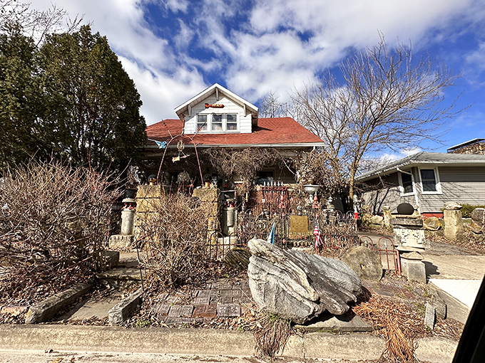 What most homeowners would call "landscaping problems," this visionary saw as building materials. The white house behind serves as an unassuming gateway to another world.