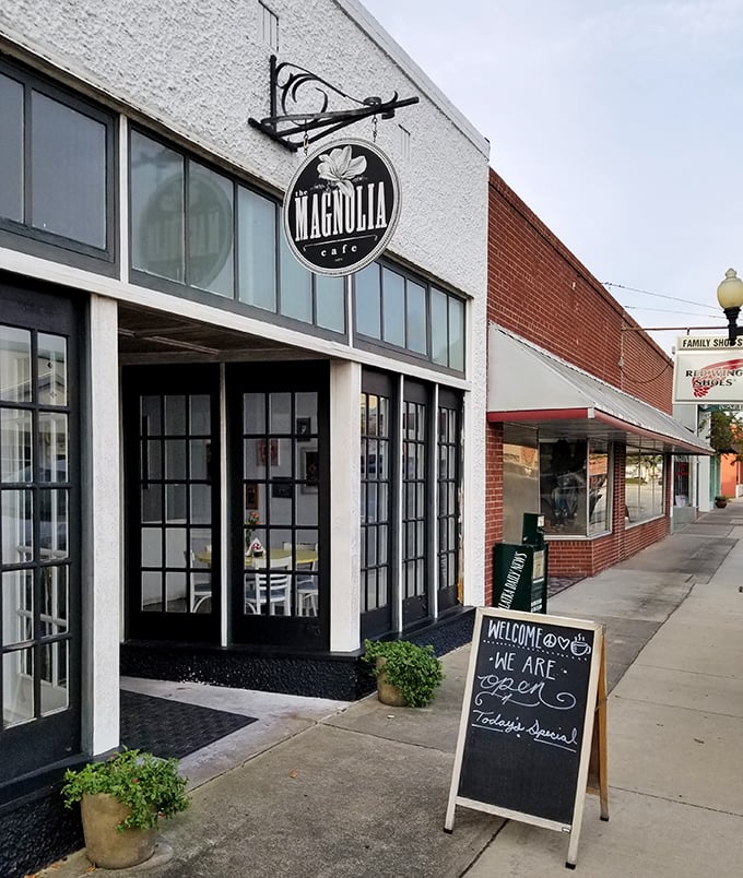 The Magnolia Cafe beckons with its charming storefront and inviting chalkboard sign &ndash; a downtown gem where locals gather for homemade comfort and conversation.