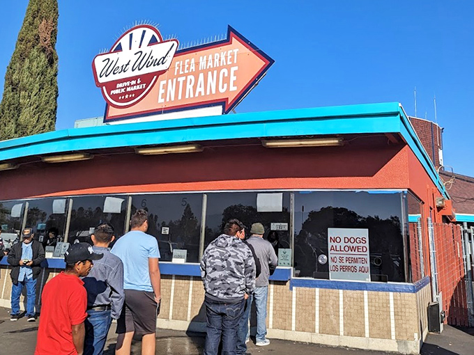 The iconic West Wind entrance sign stands as a retro beacon to bargain hunters, promising treasures that no algorithm could ever curate.