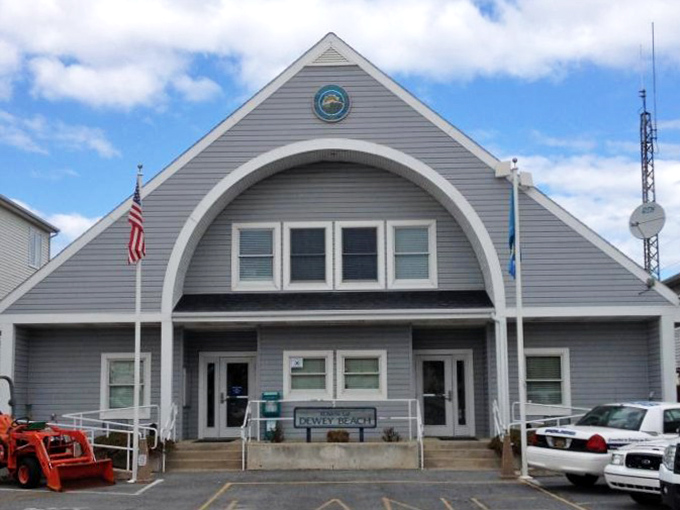 Town Hall stands like a friendly lighthouse of bureaucracy, where beach permits and summer dreams officially begin.