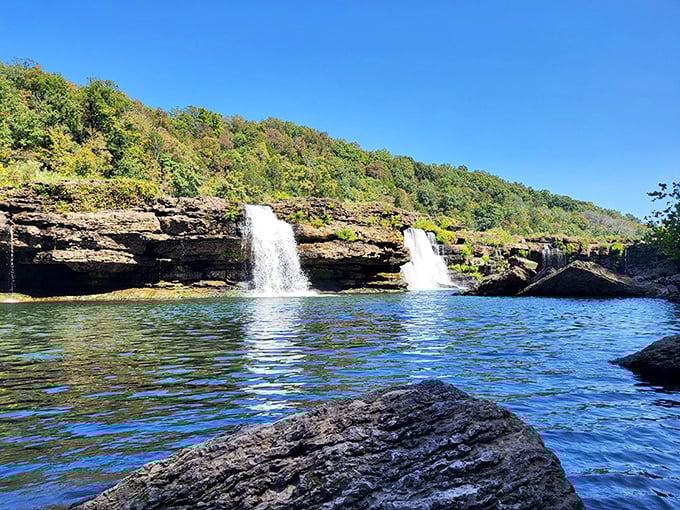 Twin Falls emerges dramatically from the limestone cliff face, proof that sometimes the best attractions are happy geological accidents.