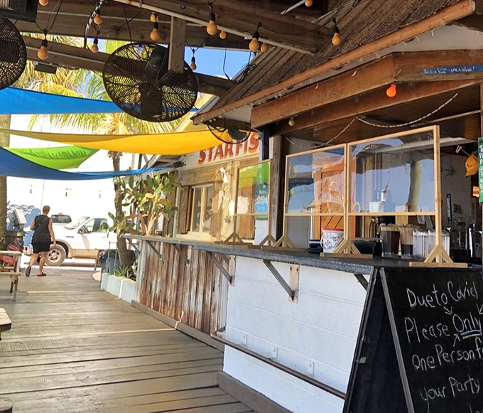 Where dining meets the dock. Colorful shade sails and rustic wood create the perfect backdrop for enjoying ultra-fresh seafood straight from Sarasota Bay.