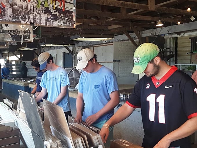 Young treasure hunters sift through vinyl records, proving that analog nostalgia crosses generational boundaries in our digital world.