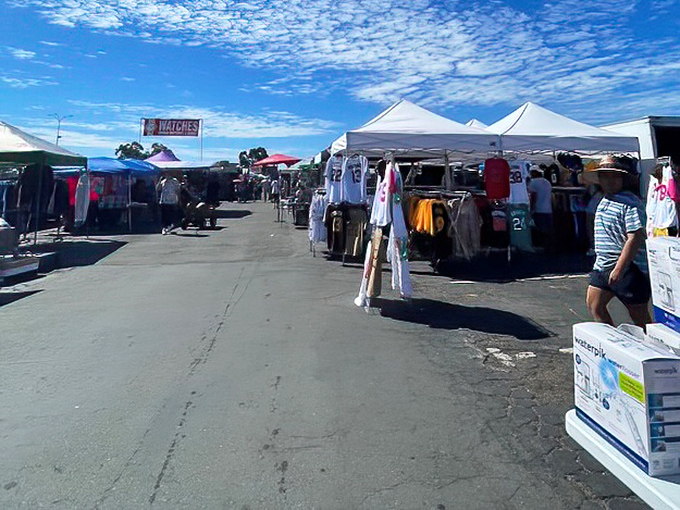 Rows of white canopies stretch into the distance, creating a labyrinth of possibility where one person's castoffs become another's prized possessions.